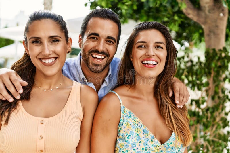 Three Hispanic Friends Smiling Happy and Hugging at the City Stock ...