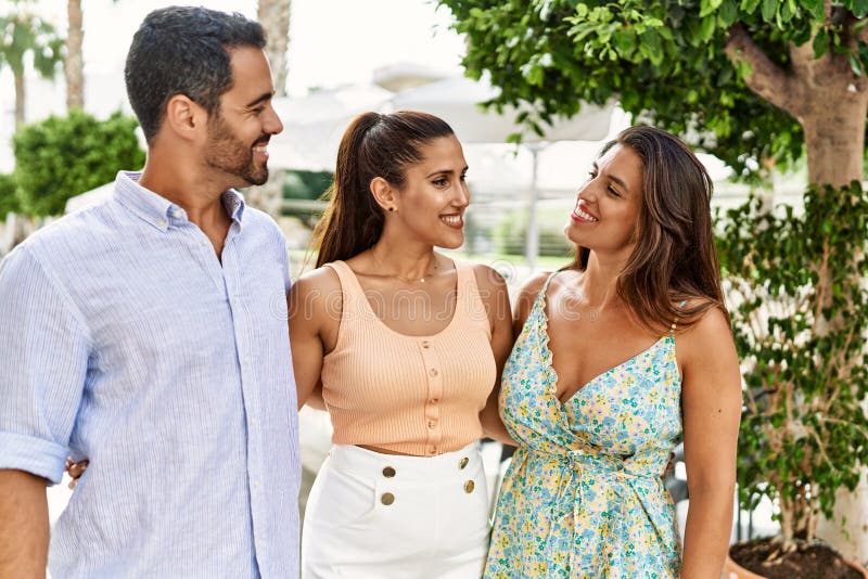 Three Hispanic Friends Smiling Happy and Hugging at the City Stock ...