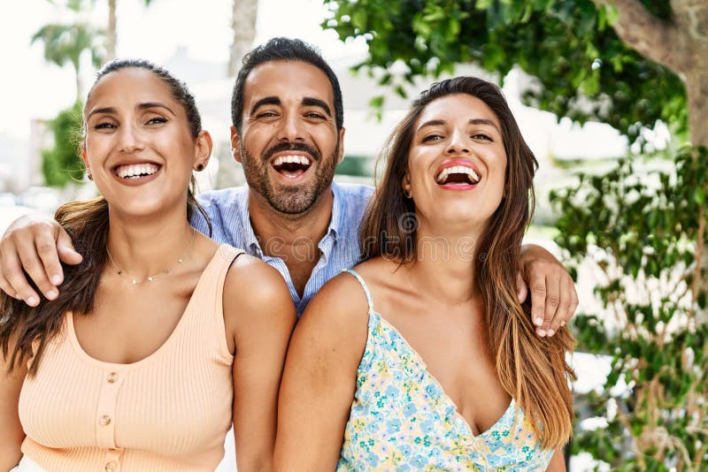Three Hispanic Friends Smiling Happy and Hugging at the City Stock ...
