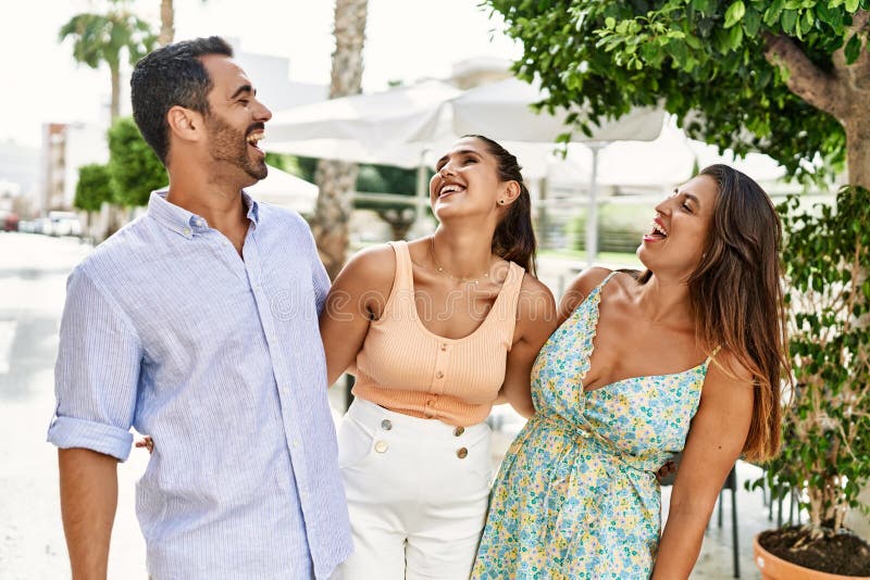 Three Hispanic Friends Smiling Happy and Hugging at the City Stock ...