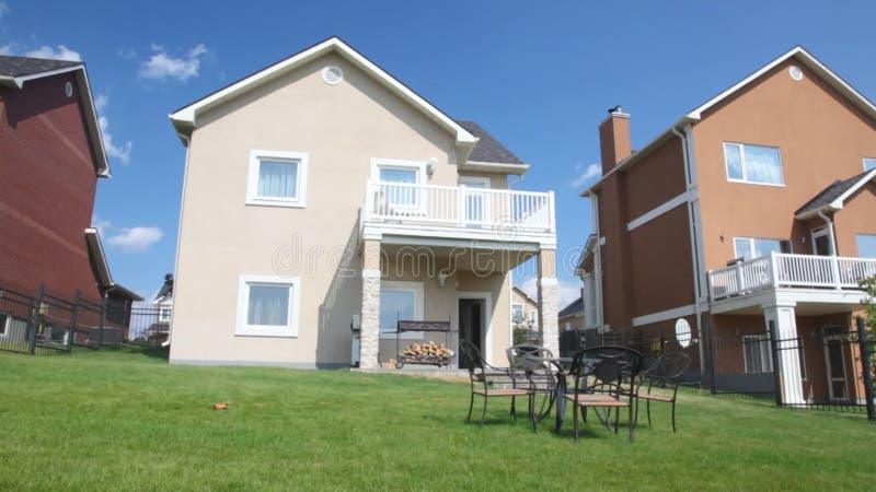 Three Houses Stand on Green Lawn Which Watered in Stock Footage - Video ...