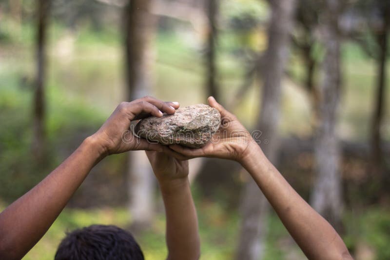 Three Human Hands Hold a Stone and the Background Blur Stock Photo ...
