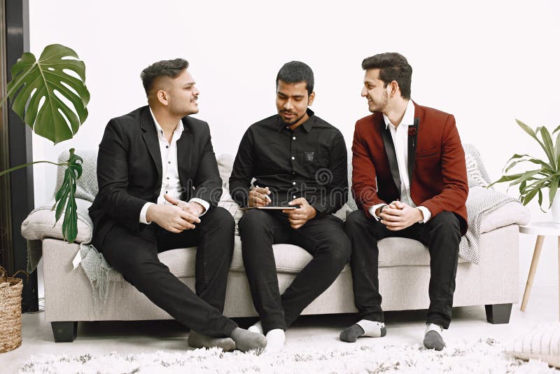 Three Indian Men Discussing Something on Couch Stock Photo - Image of ...