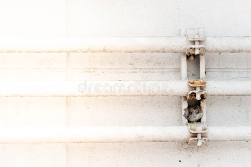 Three Industry Pipe Water with Rust Stick on the White Wall at the ...