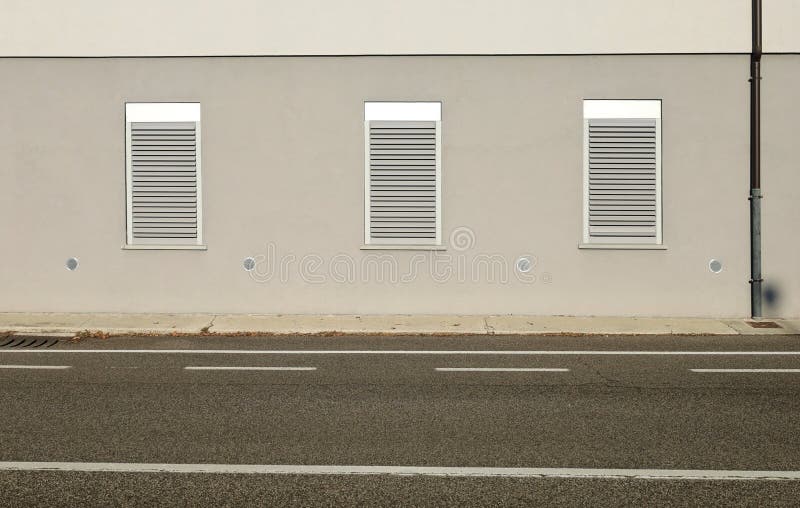 Metallic Window Shutter on a Red and Yellow Facade. Concrete Sidewalk ...