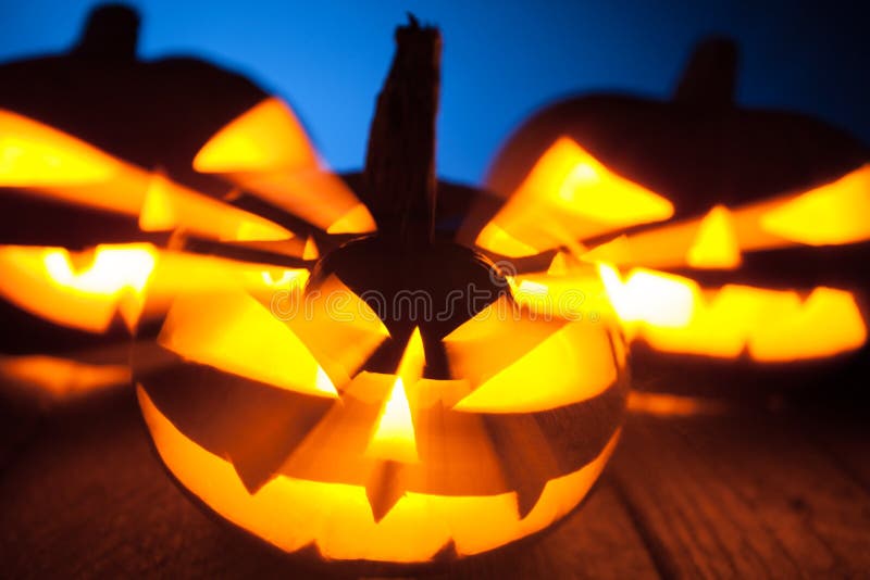 Three Jack-o-lantern Pumpkins Glowing in the Dark Stock Photo - Image ...