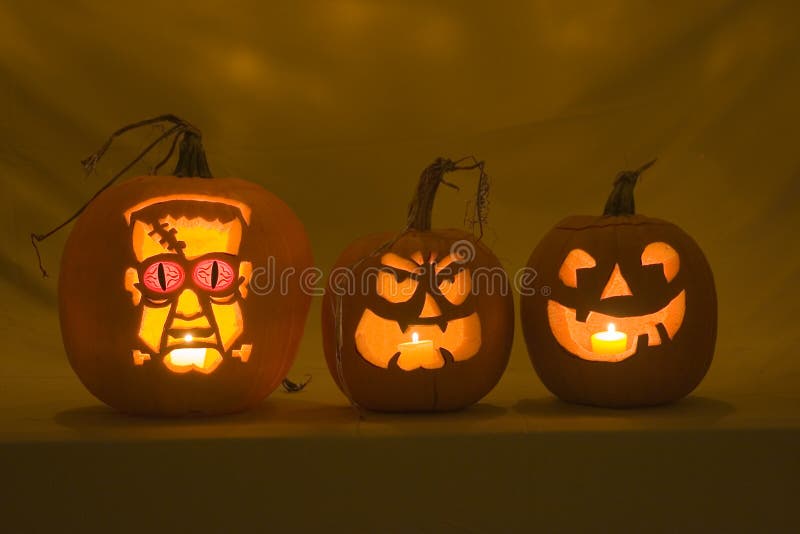 Three jack-o-Lanterns stock photo. Image of round, costumes - 1497752