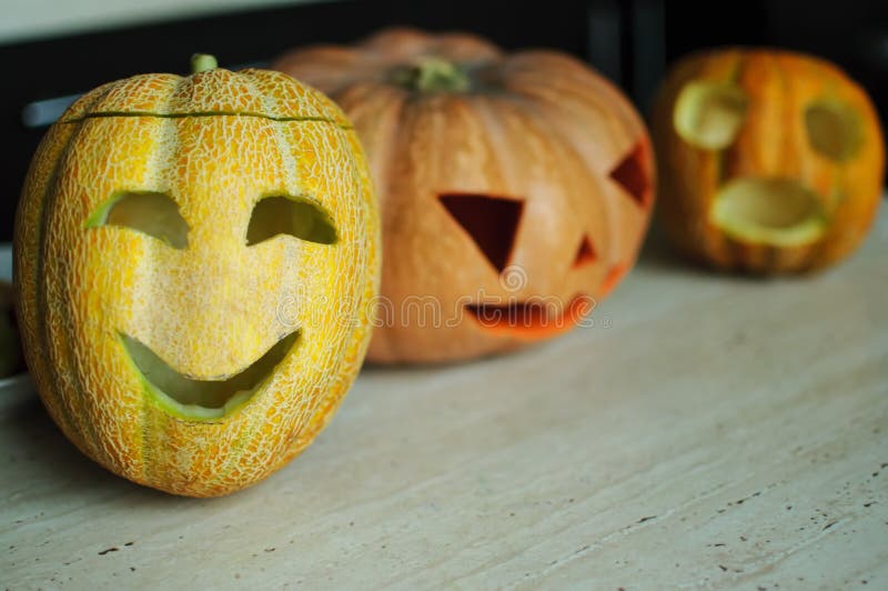 Three Jack-o`-lanterns from Pumpkin and Melons on Kitchen Table. Stock ...