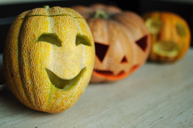 Three Jack-o`-lanterns from Pumpkin and Melons on Kitchen Table. Stock ...