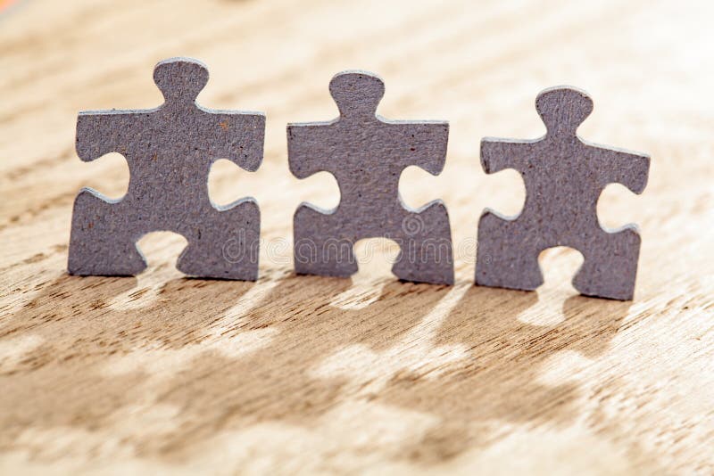 Three Jigsaw Puzzle Pieces on Table Stock Image - Image of three ...