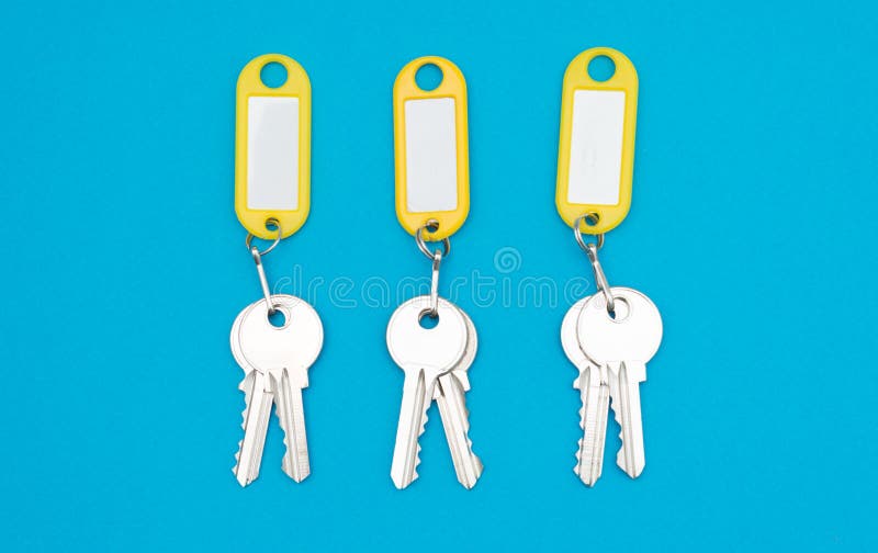 Three Keys Pair on Yellow Keychains Blue Background Stock Photo - Image ...