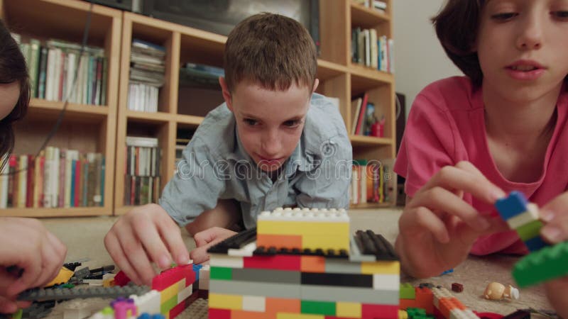 Three Kids Playing with Lego Bricks at Home Stock Video - Video of ...