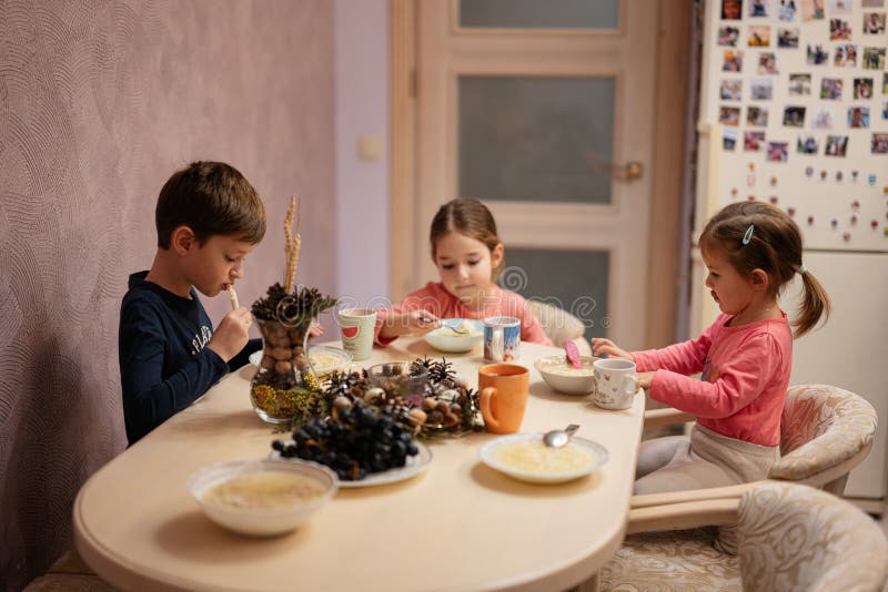 Three Kids Have Dinner Together in the Kitchen Stock Photo - Image of ...