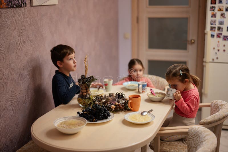 Three Kids Have Dinner Together in the Kitchen Stock Photo - Image of ...