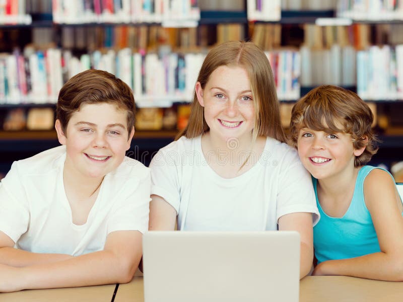 Three kids in library stock image. Image of casual, ebook - 53122905