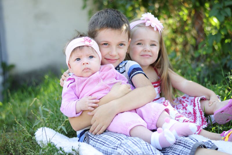Three kids near colors stock photo. Image of children - 34267974
