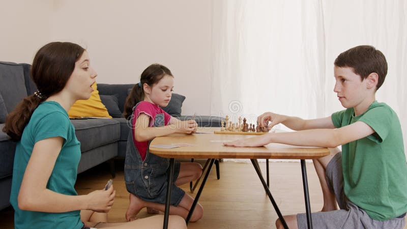 Three Kids Playing a Crad Game in the Living Room, Shouting and Arguing ...