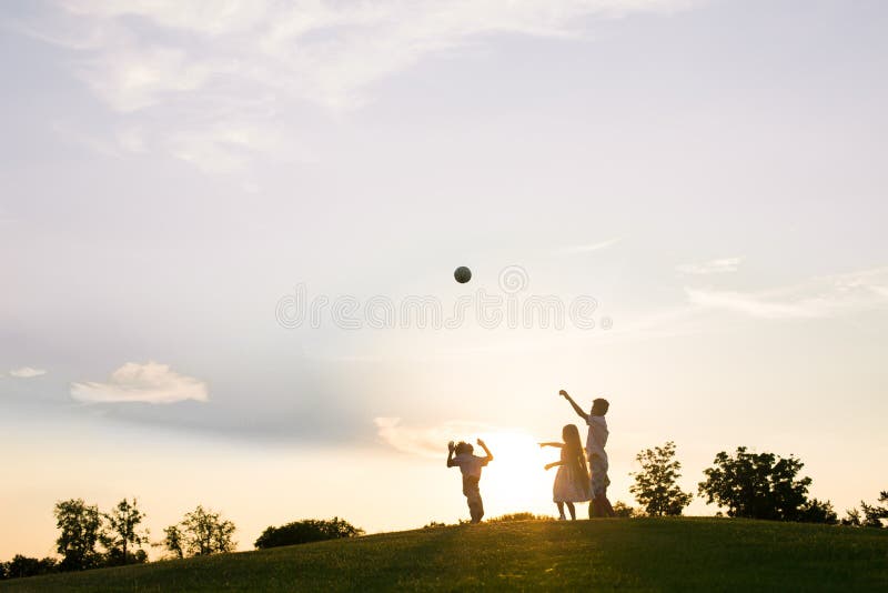 Three Kids are Playing on Sunset. Stock Photo - Image of interest ...