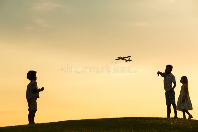 Three kids on sunset. stock photo. Image of dark, lawn - 56154464