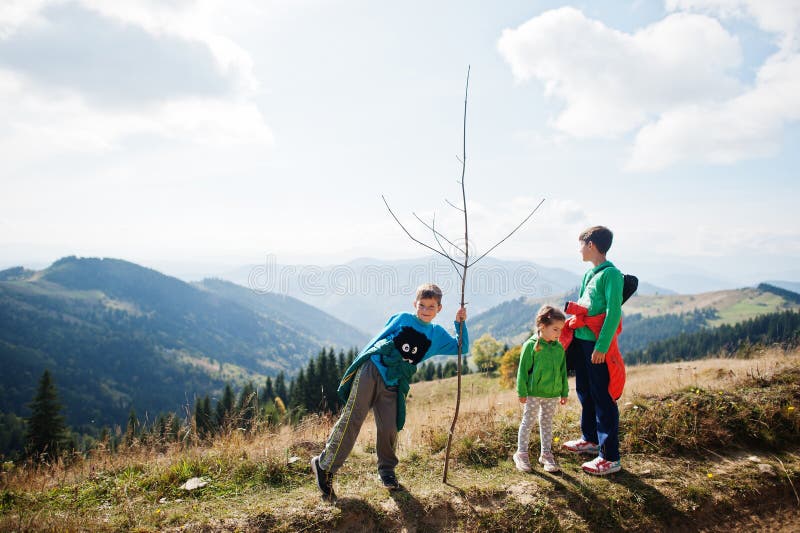 Three Kids on a Trekking Day in the Mountains. Top of Mountain Stock ...