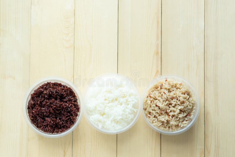 Three Kinds of Cooked Rice in Plastic Bowls on Wooden Table Stock Image ...