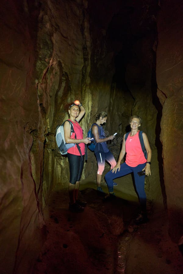 Three Ladies Exploring a Cave Stock Image - Image of geologic, exploring: 294888185