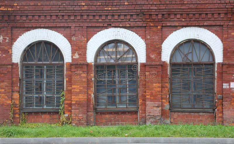 Three Large Arched Windows in an Old Red Brick Wall Stock Photo - Image ...