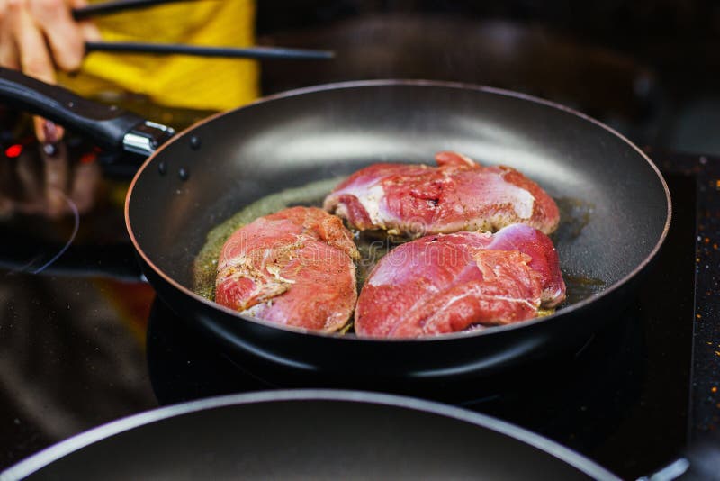 Three Large Fresh Piece of Meat in a Frying Pan. Stock Photo - Image of ...