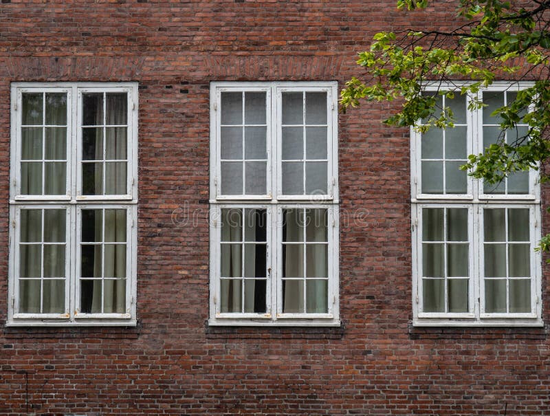Three Large Rectangular Windows with White Metal Bars on the Facade of ...
