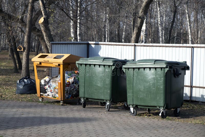 Three Large Trash Cans in the Park. One of Them is for Plastic Stock ...