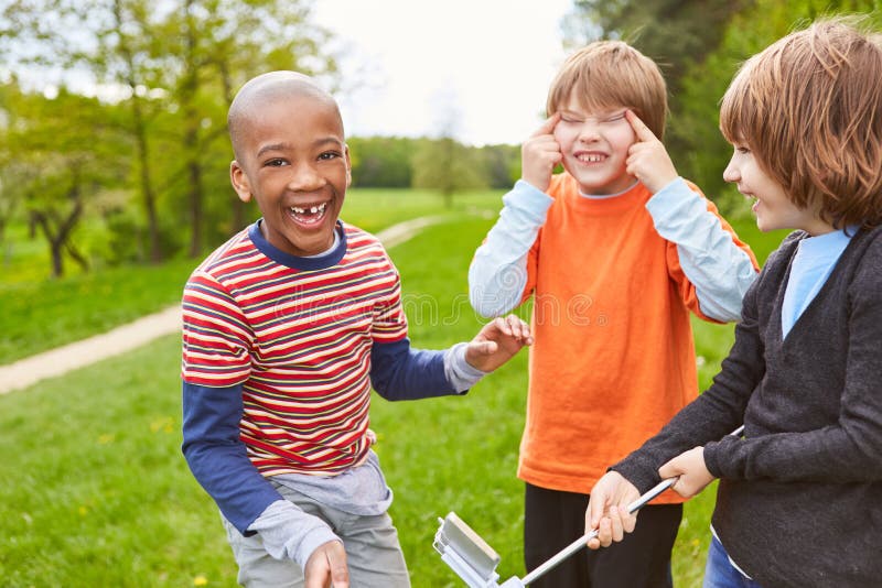 Three Laughing Kids As Friends are Having Fun Stock Image - Image of ...