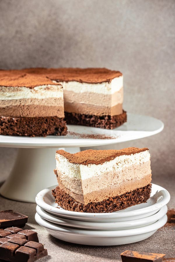 Three Layered Chocolate Mousse Cake on a Light Background. Vertical ...