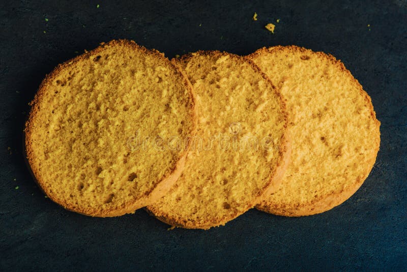 Three Layers of a Traditional Sponge Cake Side by Side on a Dark ...