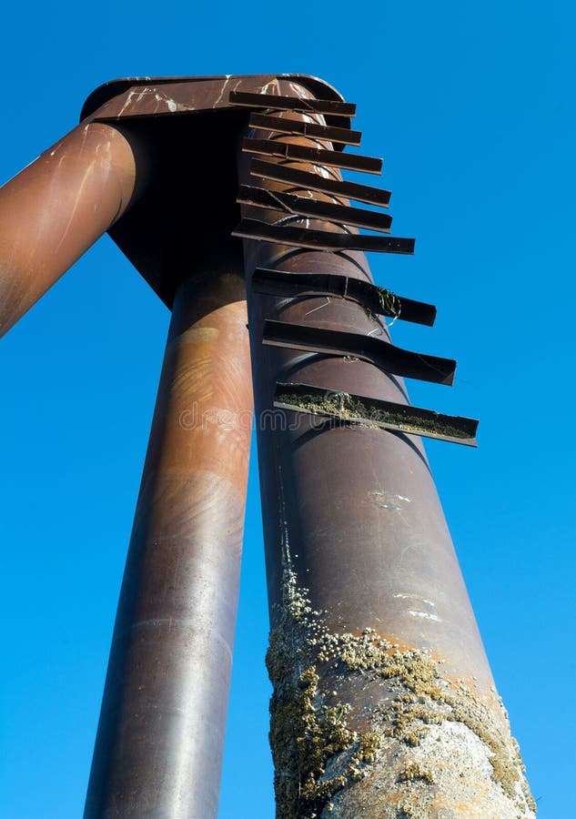 Three Legged Piling with Ladder Stock Image - Image of legs, metal ...
