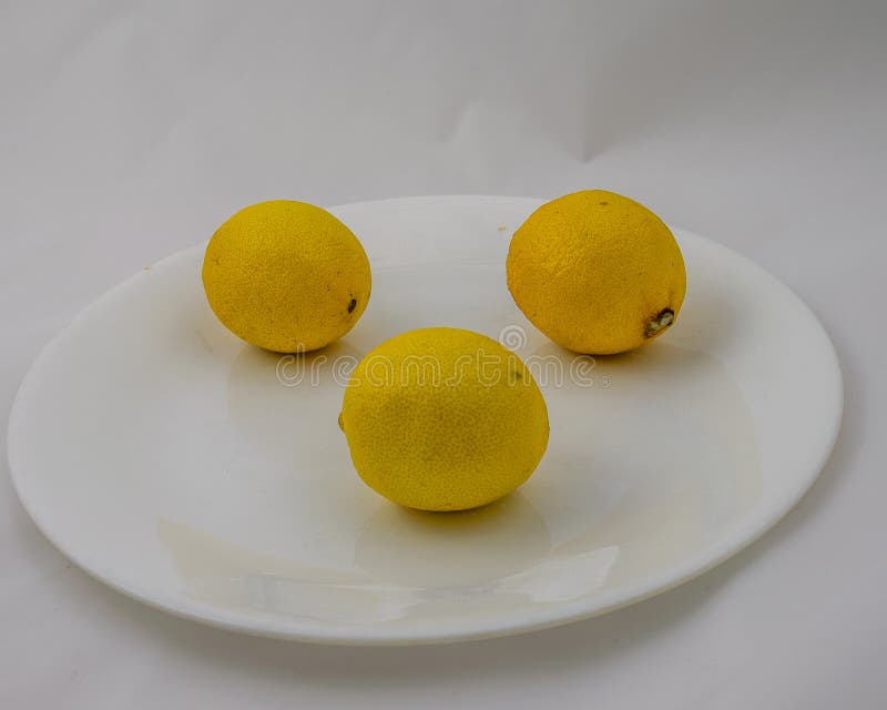 Three Lemons on a Plate stock image. Image of white, tart - 86593571