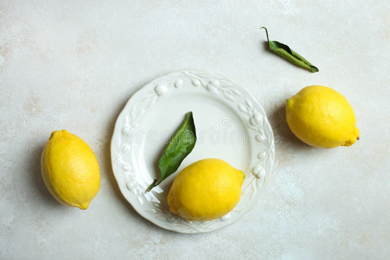 Three lemons and a plate stock photo. Image of organic - 118498820