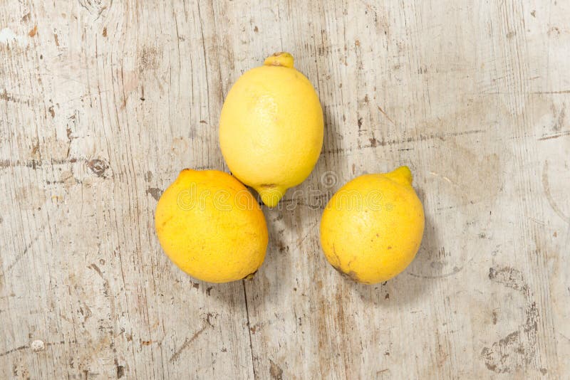Three Lemons on a Wooden Surface Stock Photo - Image of ingredient ...
