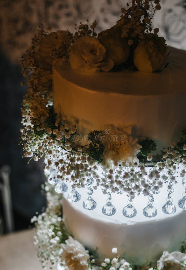 Three-level Wedding Cake on a Decorative Stand with Hanging Levels ...
