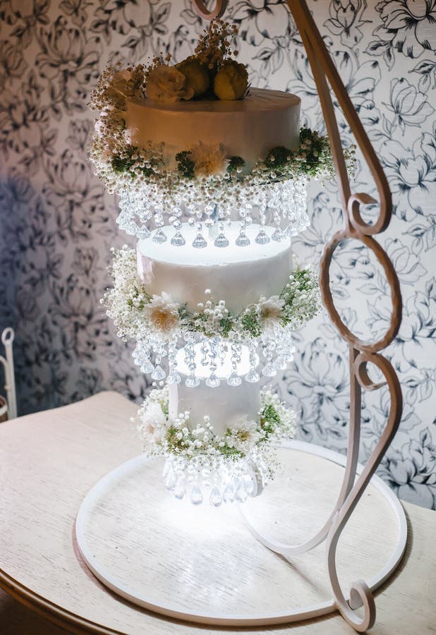 Three-level Wedding Cake on a Decorative Stand with Hanging Levels ...