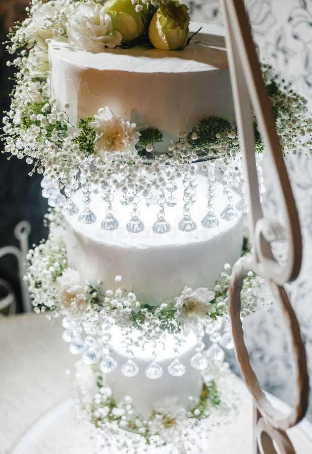 Three-level Wedding Cake on a Decorative Stand with Hanging Levels ...