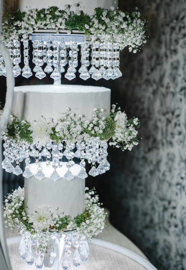 Three-level Wedding Cake on a Decorative Stand with Hanging Levels ...