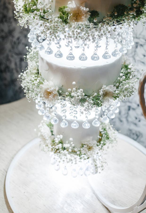 Three-level Wedding Cake on a Decorative Stand with Hanging Levels ...
