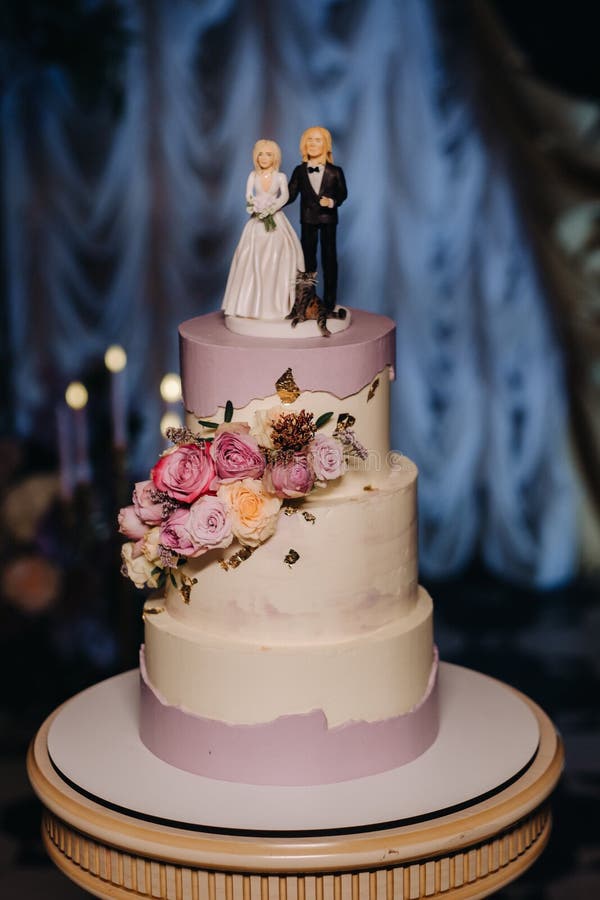 Three-level Wedding Cake with Figures of People on it Stock Photo ...