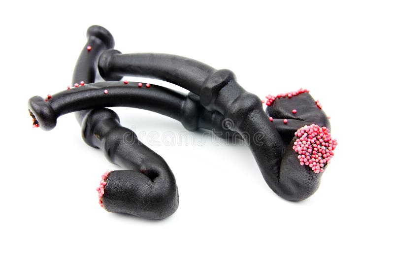 Three Licorice Pipes with Red Spheres Stock Image - Image of ...