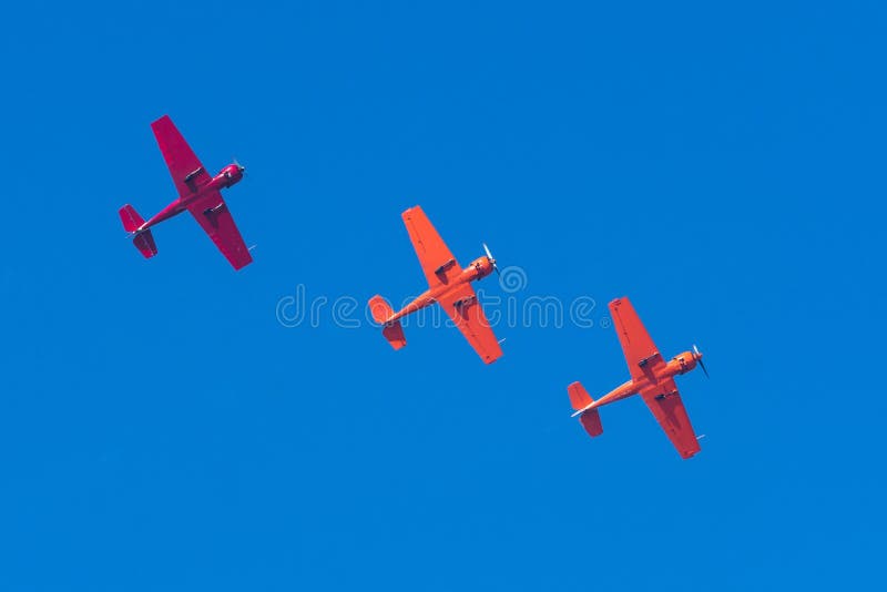 Three Light-engine Turboprop Red Aircraft Fly in Formation in a ...