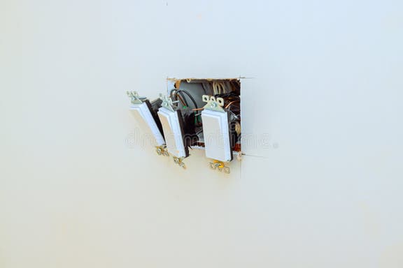 Three Light Switches Installed in a Newly Built Wall for a Modern ...