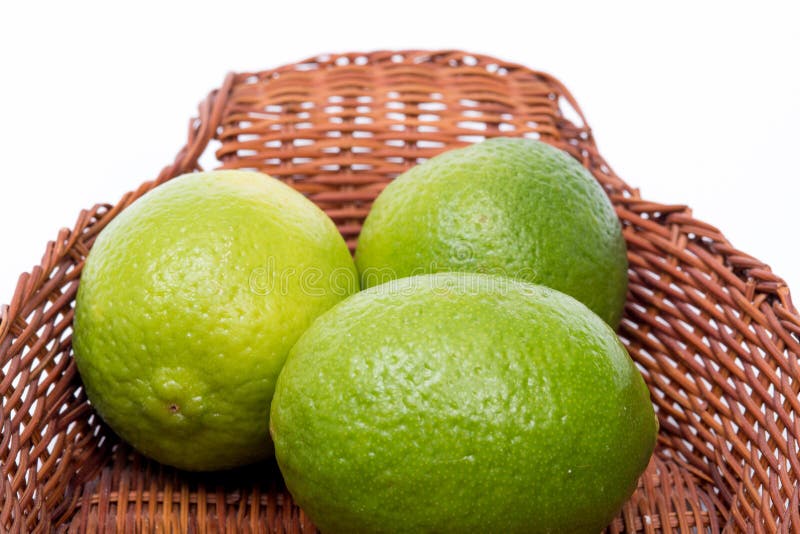 Three limes in a basket stock photo. Image of group, isolated - 54258866