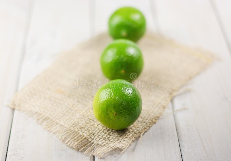 Three Limes on a Wooden Table. Stock Image - Image of limes, fruit ...