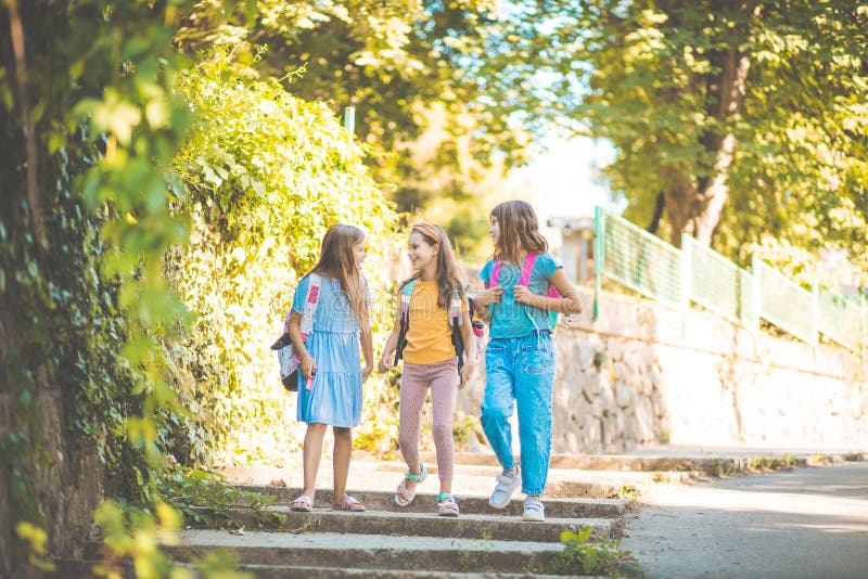 Three Little Girls Walking Trough Park and with School Bas Stock Image ...