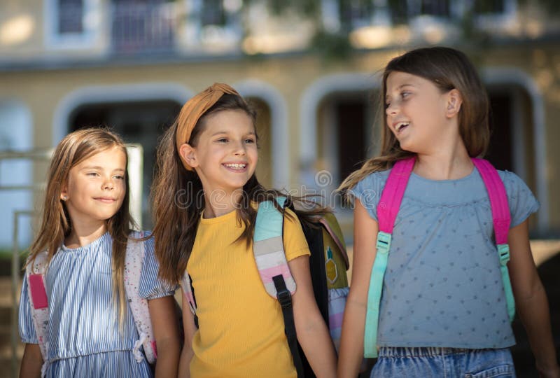 Three Little Smiling Girls Going Home after School Stock Photo - Image ...